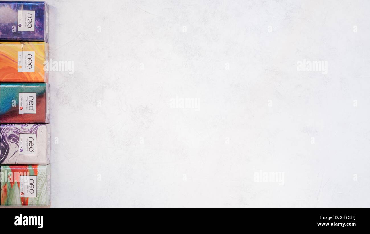 Packs of Neo smoking sticks with different flavors on white concrete ...