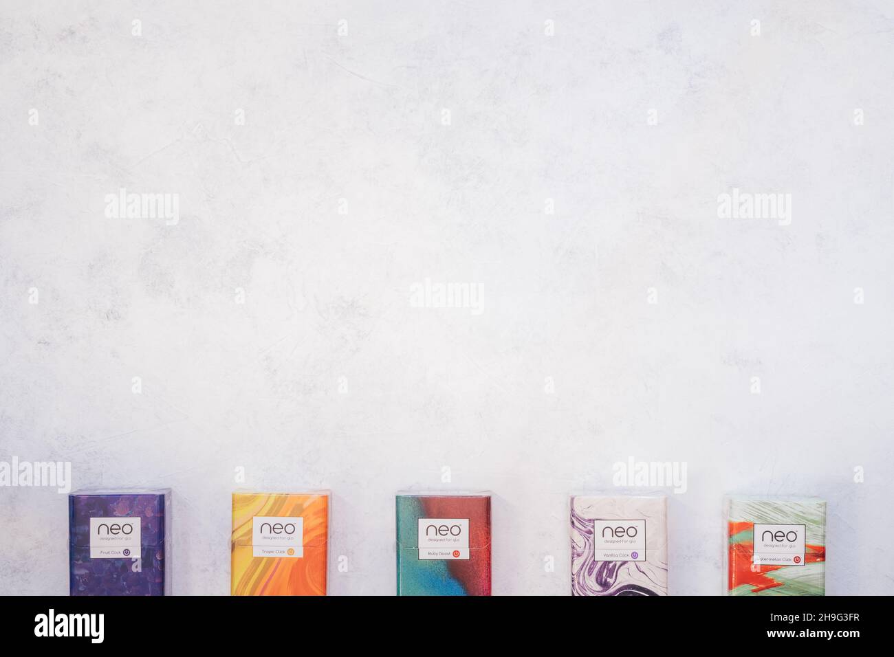 Packs of Neo smoking sticks with different flavors on white concrete ...