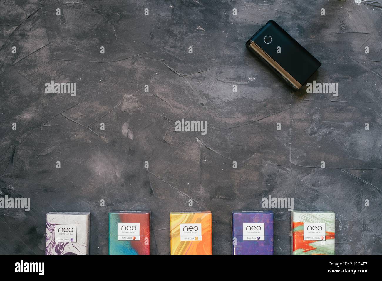 Packs of Neo smoking sticks with different flavors on gray concrete ...