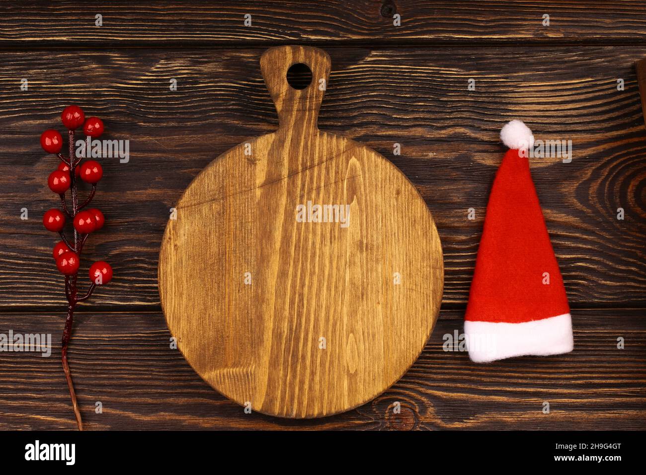 Christmas culinary layout on a wooden background. Wooden cutting board ...