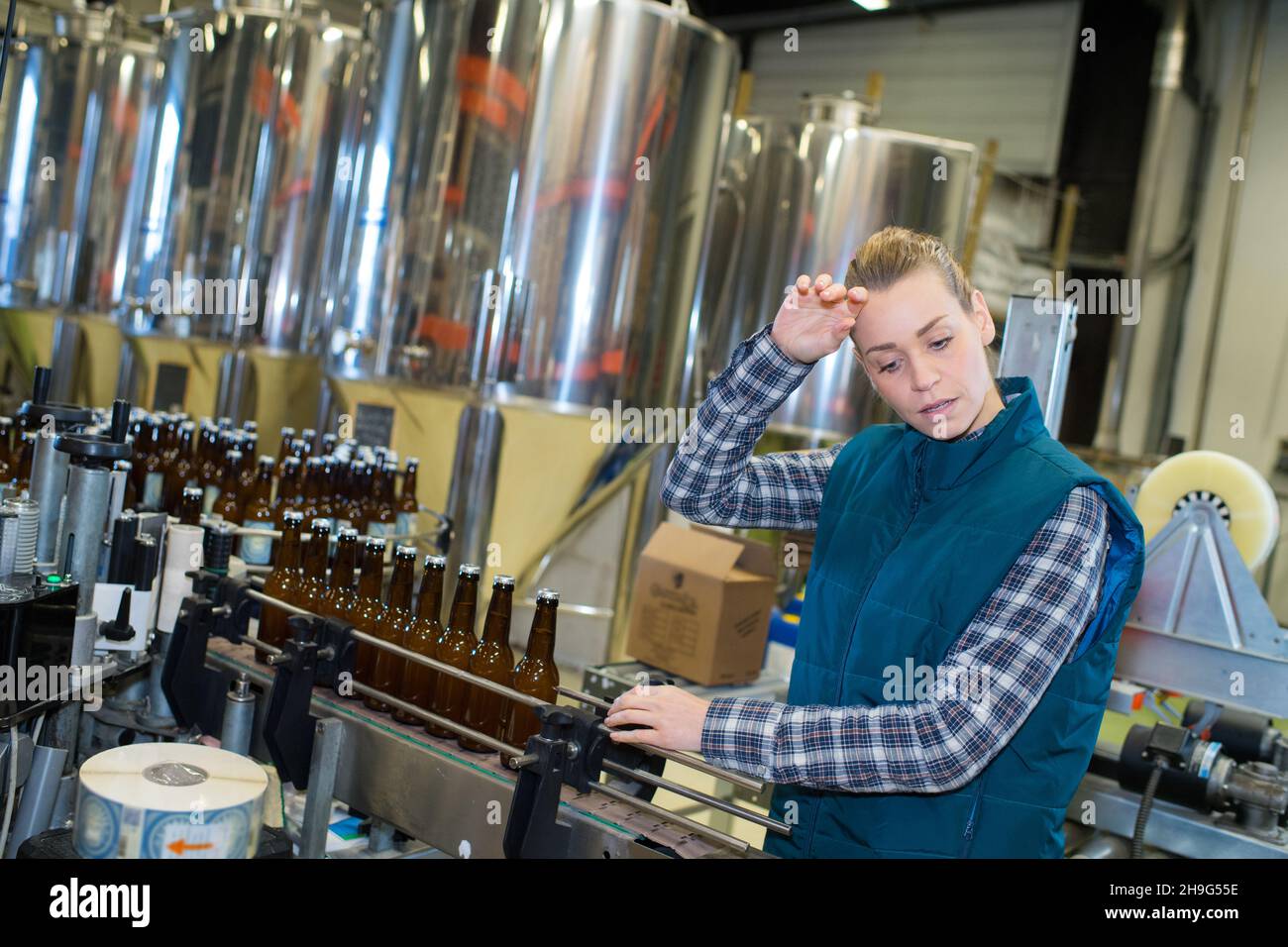 tired young attractive female brewery worker Stock Photo - Alamy