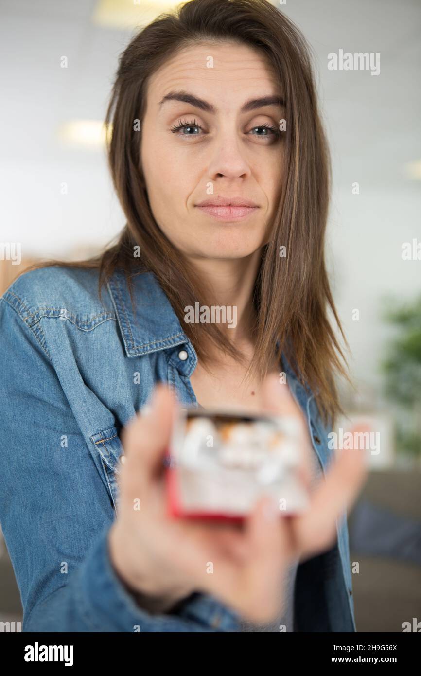 unhealthy woman offering a cigarette Stock Photo - Alamy