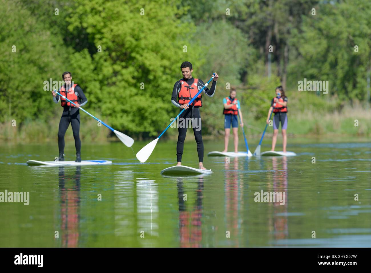group of people stand up paddleboarding Stock Photo - Alamy