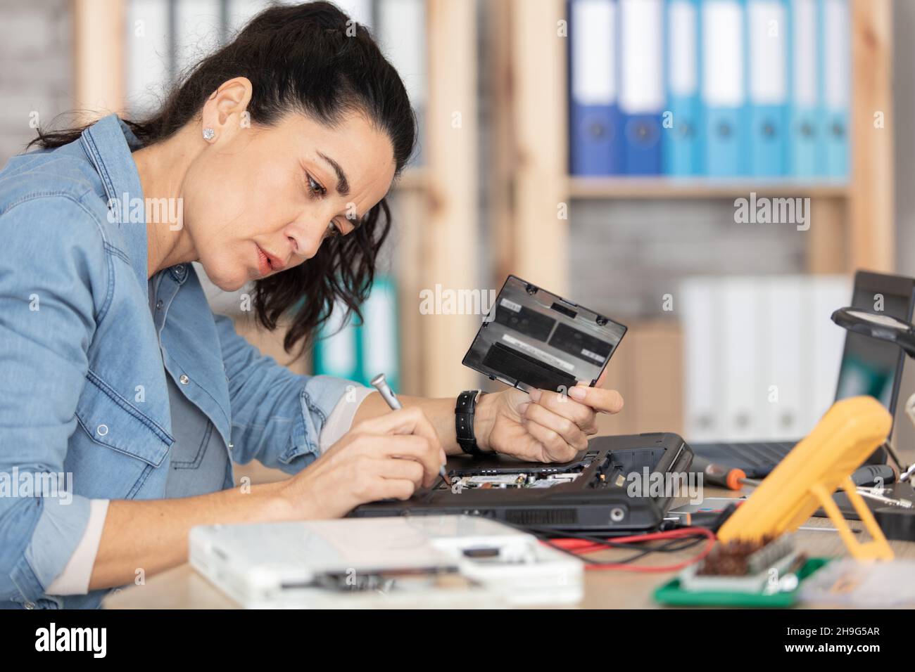 mature woman repairs a computer Stock Photo - Alamy