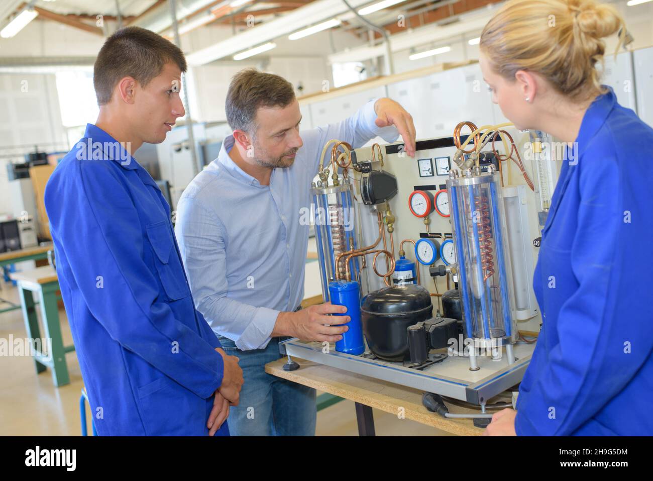 team of workers and technical science demonstration Stock Photo - Alamy