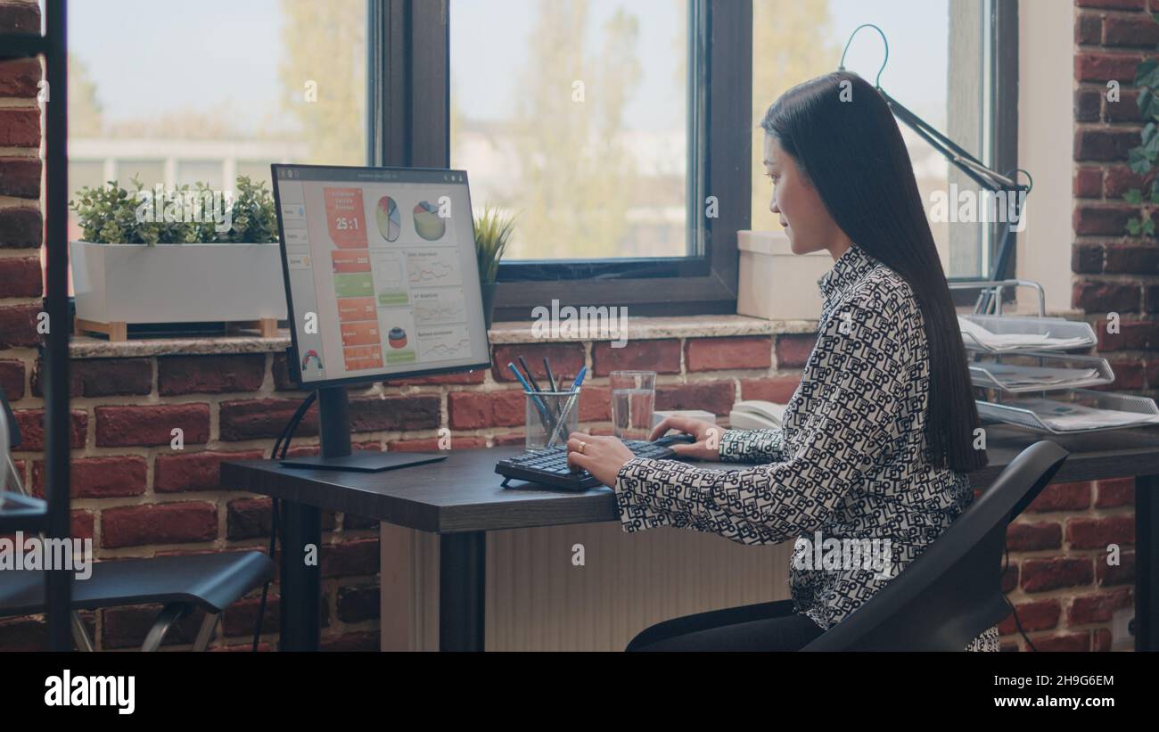 Business woman doing data analysis on computer to work on finance and ...