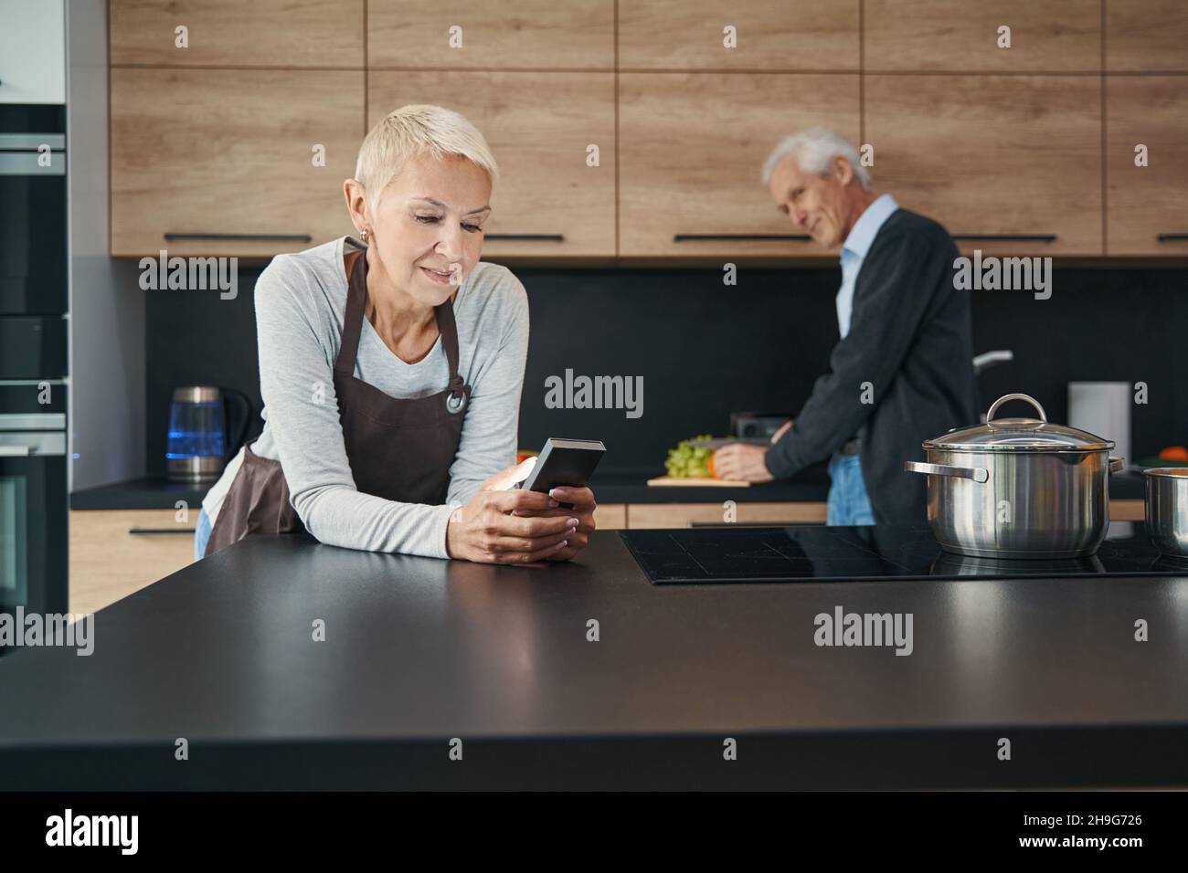 Relaxed aged woman chatting with her friend Stock Photo - Alamy