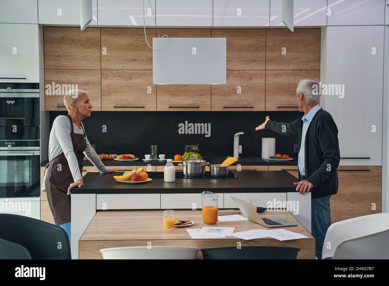 Emotional male person pointing at kitchen countertop Stock Photo - Alamy