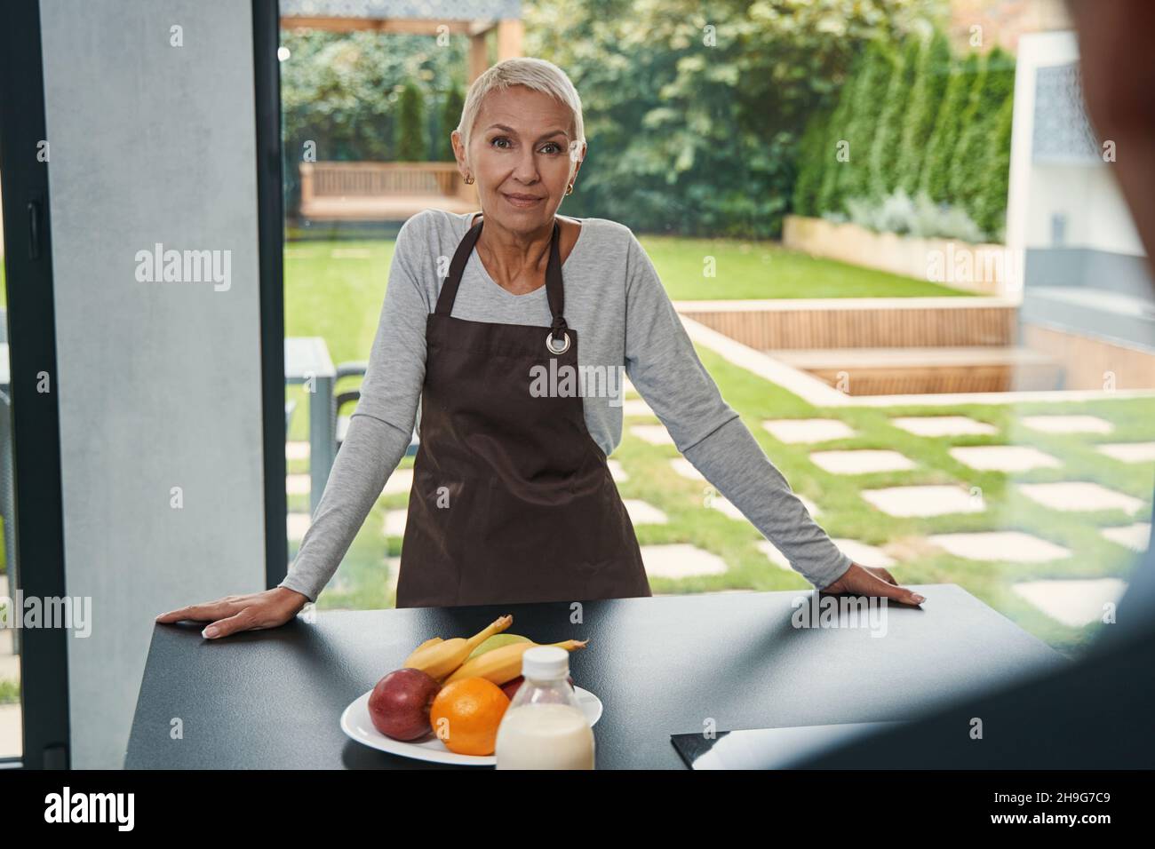 Kind female person standing on glass wall background Stock Photo - Alamy