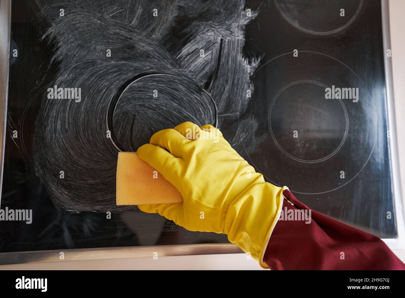 Professional janitor cleaning cooking surface with detergent Stock ...