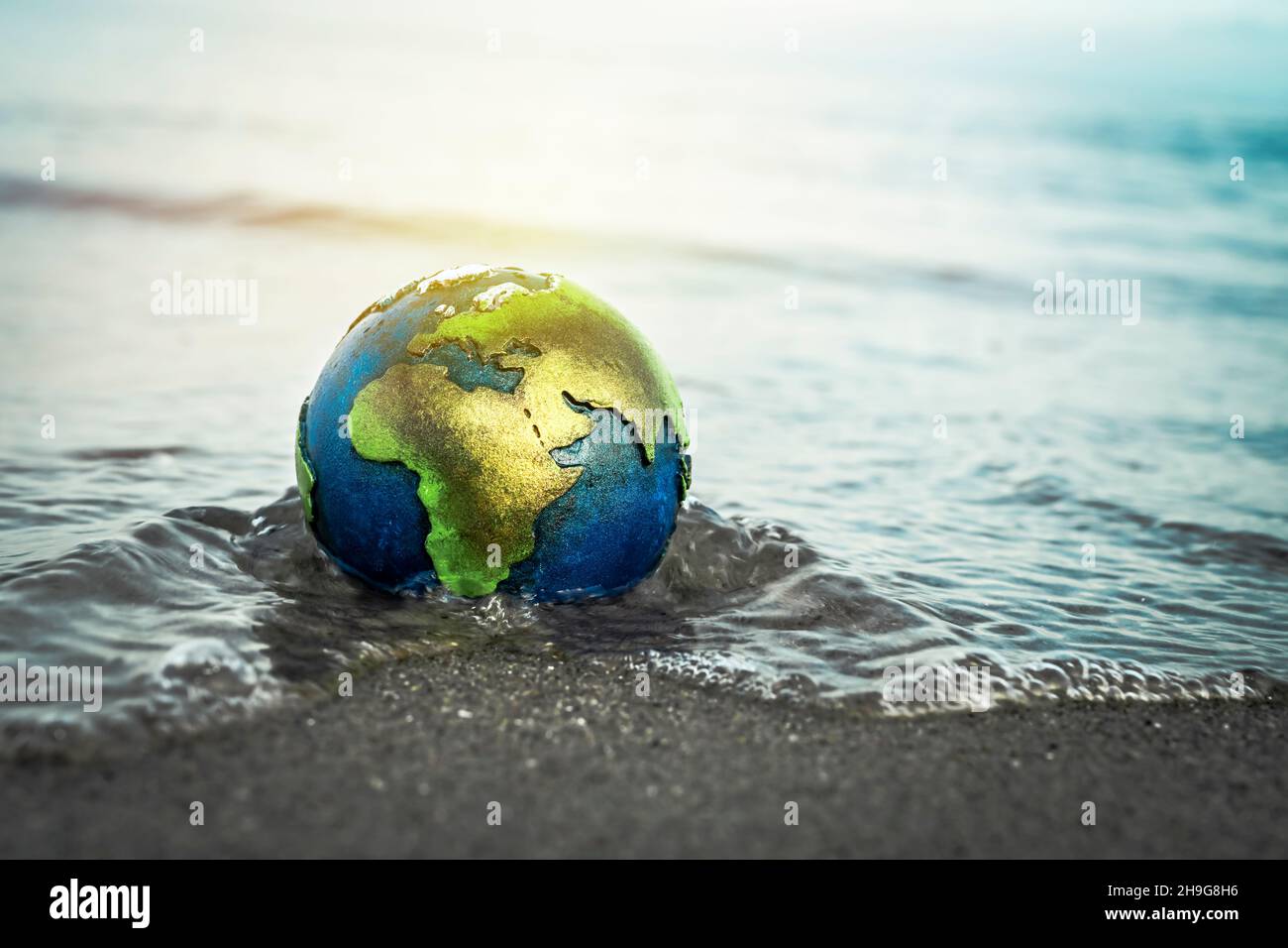 Globe in the water, climate change Stock Photo - Alamy