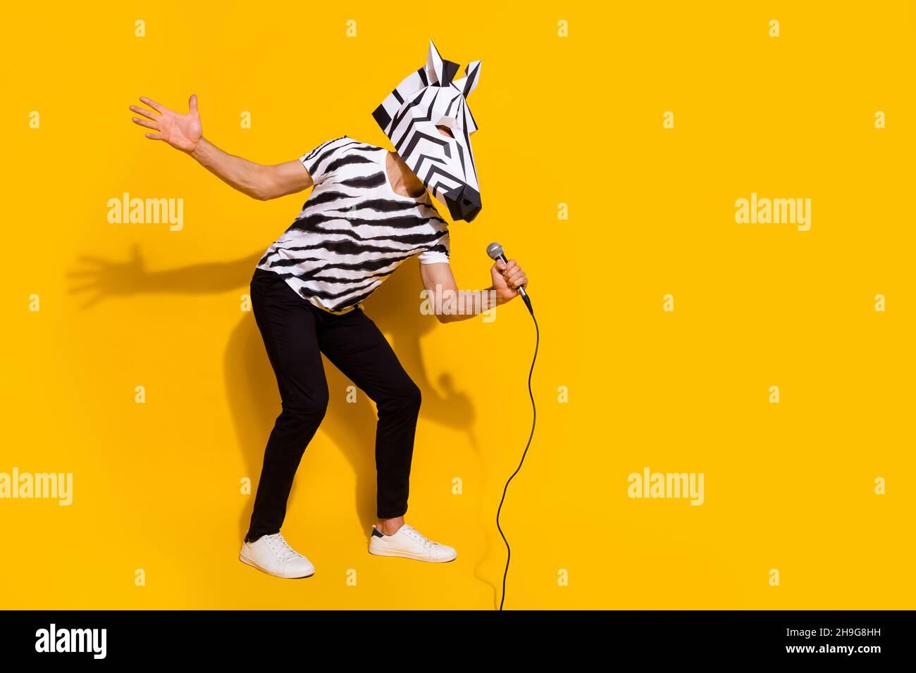 Full size photo of bizarre authentic guy rocker in zebra mask sing song ...