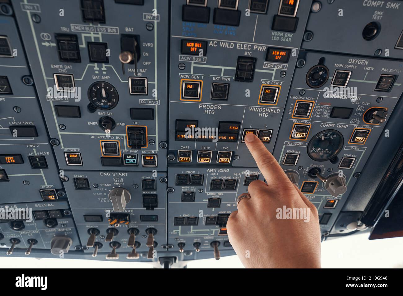 Pilot toggling switch for windshield heating in cockpit Stock Photo - Alamy