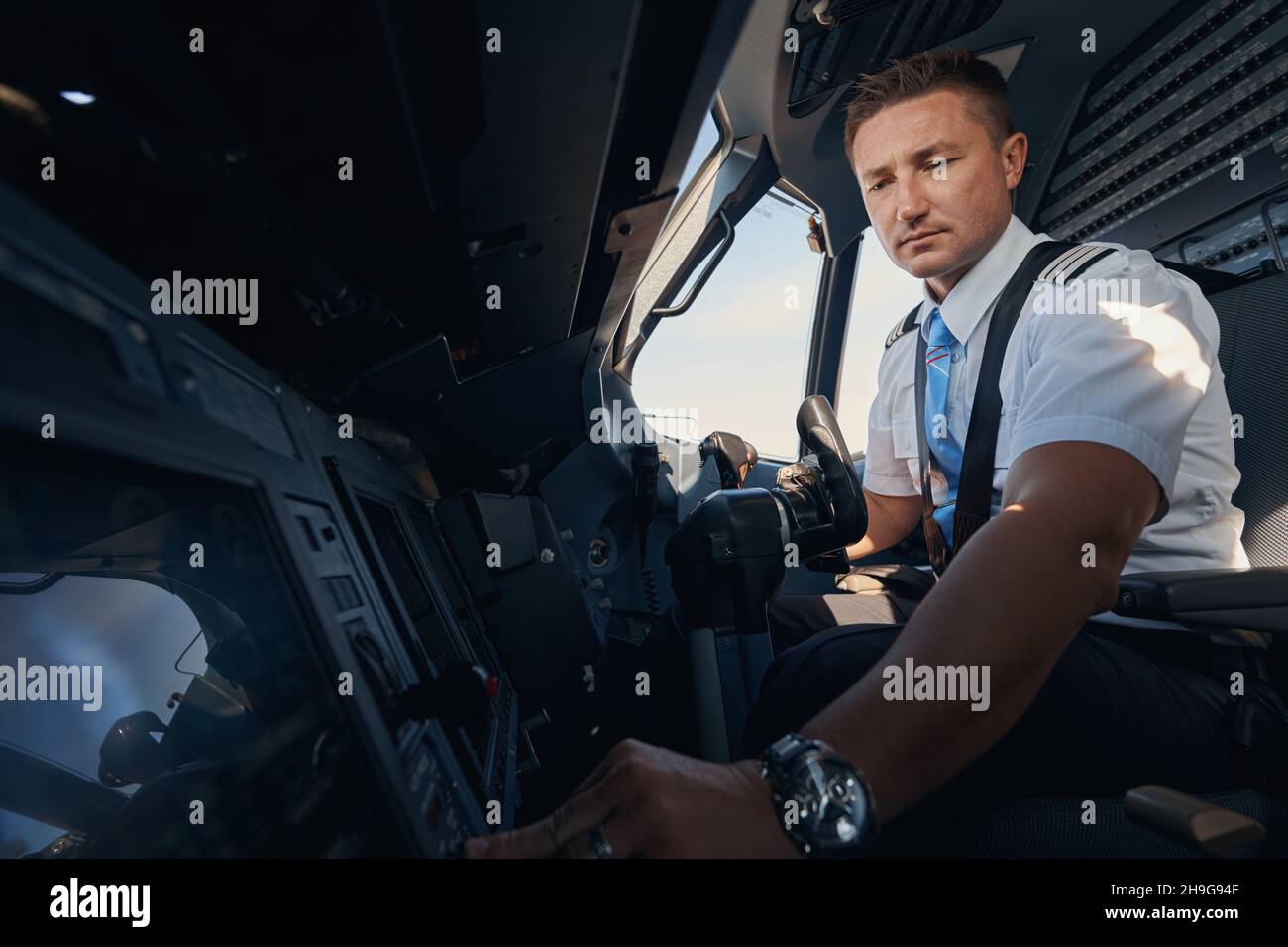 Second pilot pressing switch from his seat in cockpit Stock Photo - Alamy