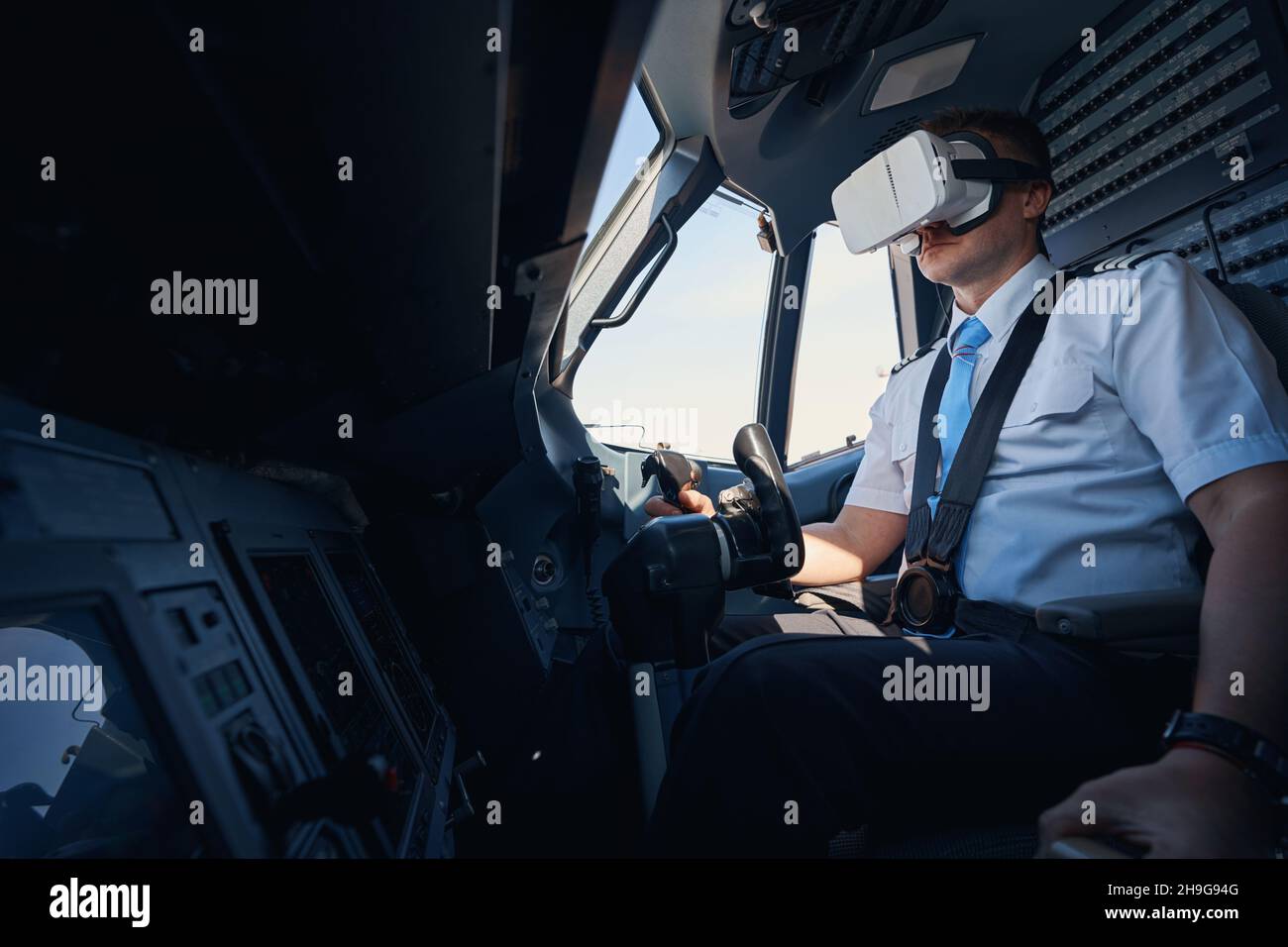 Pilot in cockpit sitting with VR headset Stock Photo - Alamy