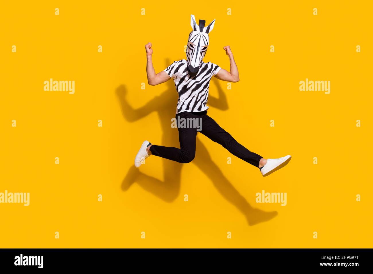 Full length photo of freak bizarre guy in zebra mask jump up show ...
