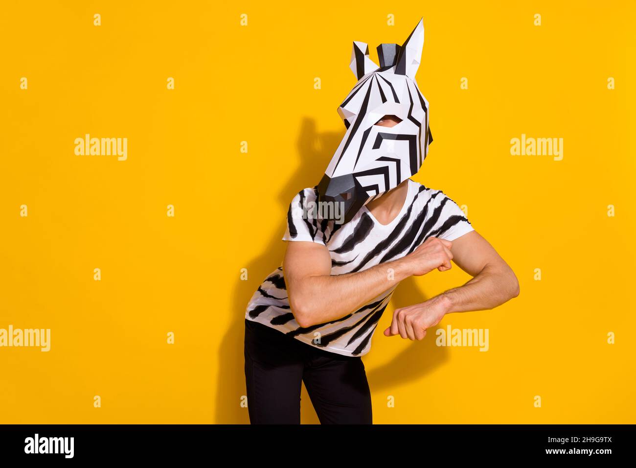 Photo of energetic weird incognito guy in zebra costume dancing ...