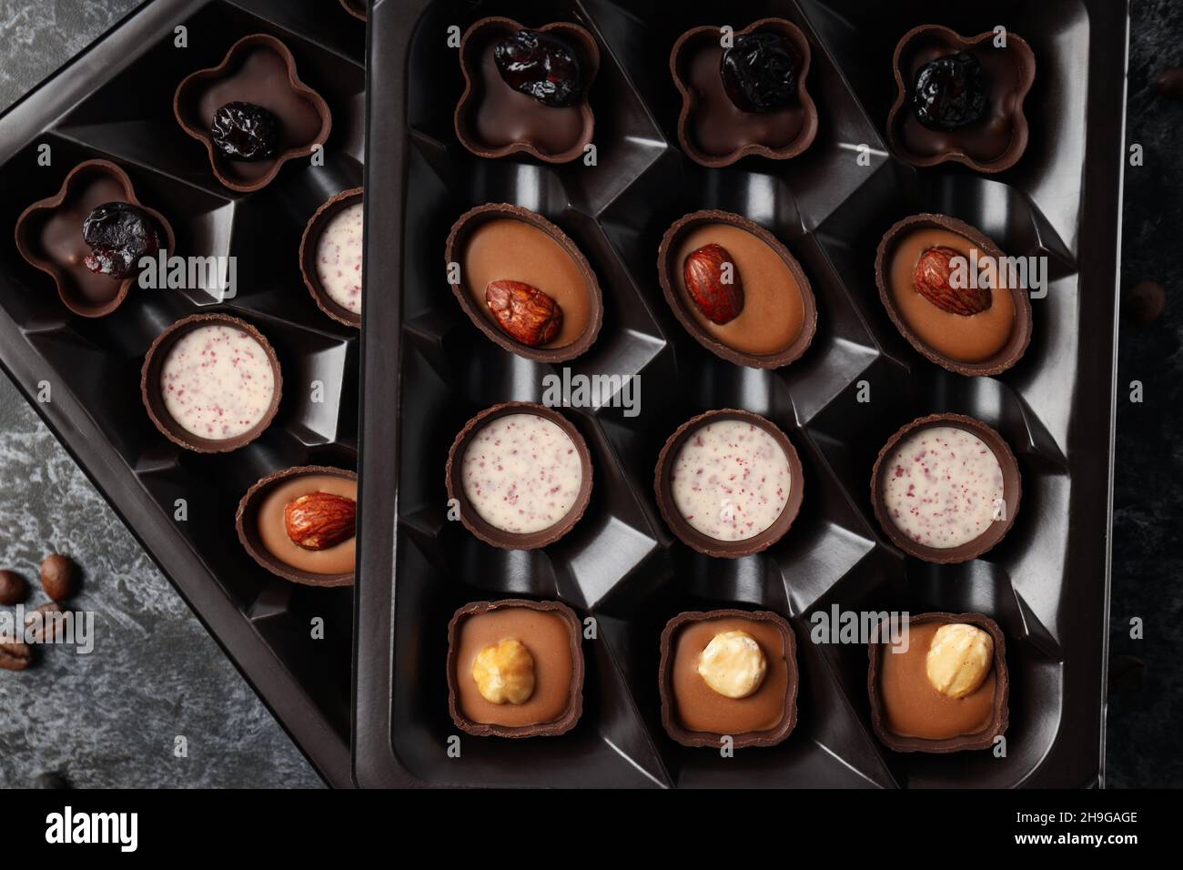 Concept of sweets with chocolate candies on dark textured background ...