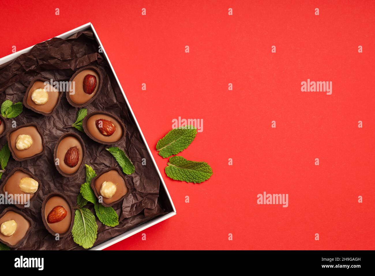 Concept of sweets with chocolate candies on red background Stock Photo ...