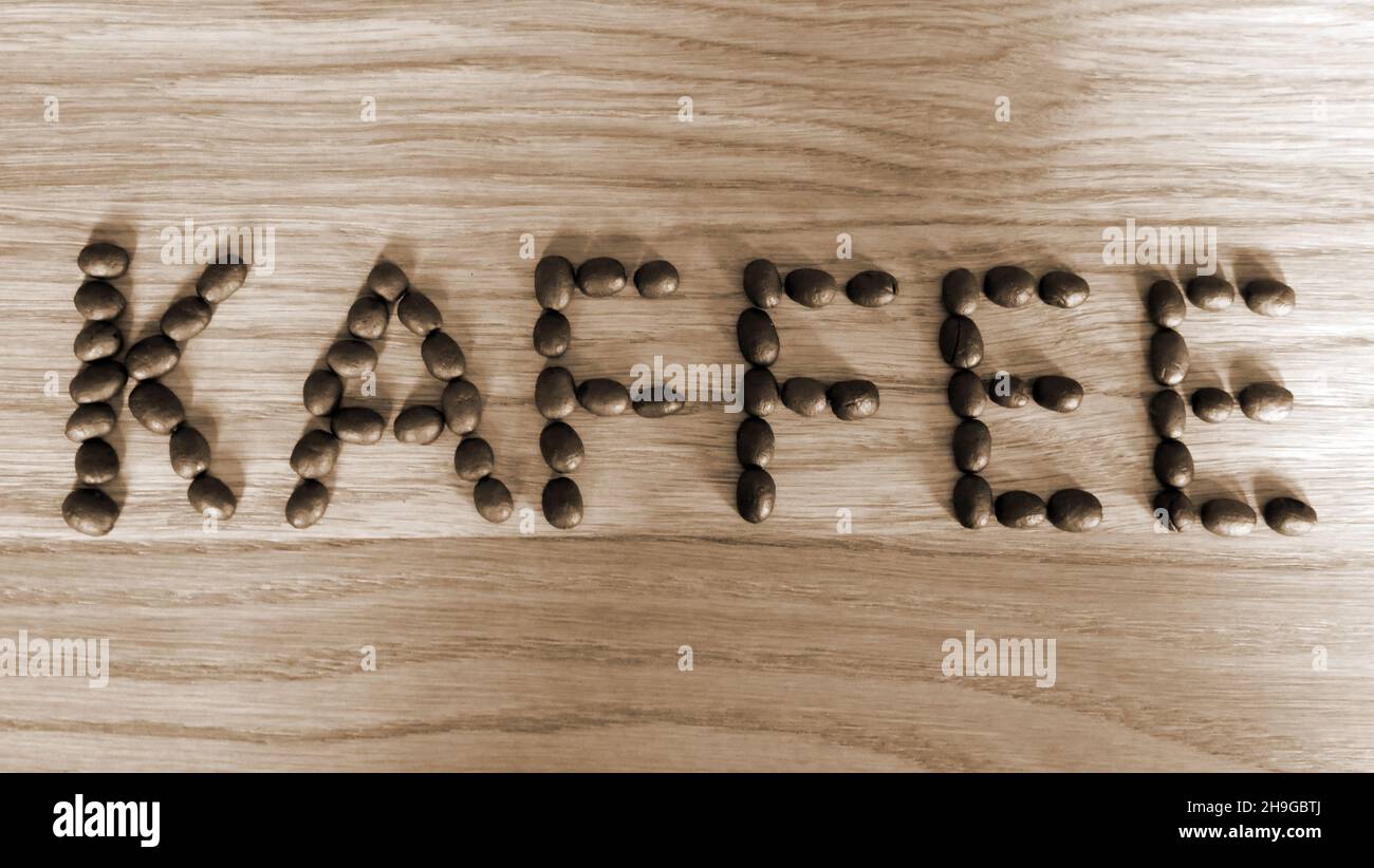 Coffee Lettering Made Of Coffee Beans On Wood Stock Photo - Alamy