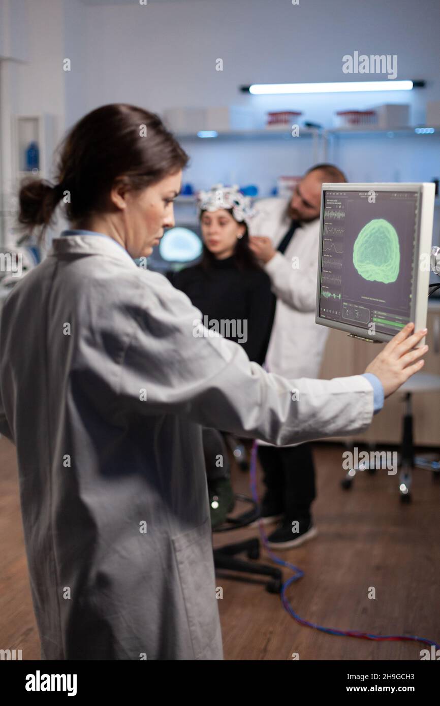 Neurologist specialist analyzing nervous system tomography on monitor ...