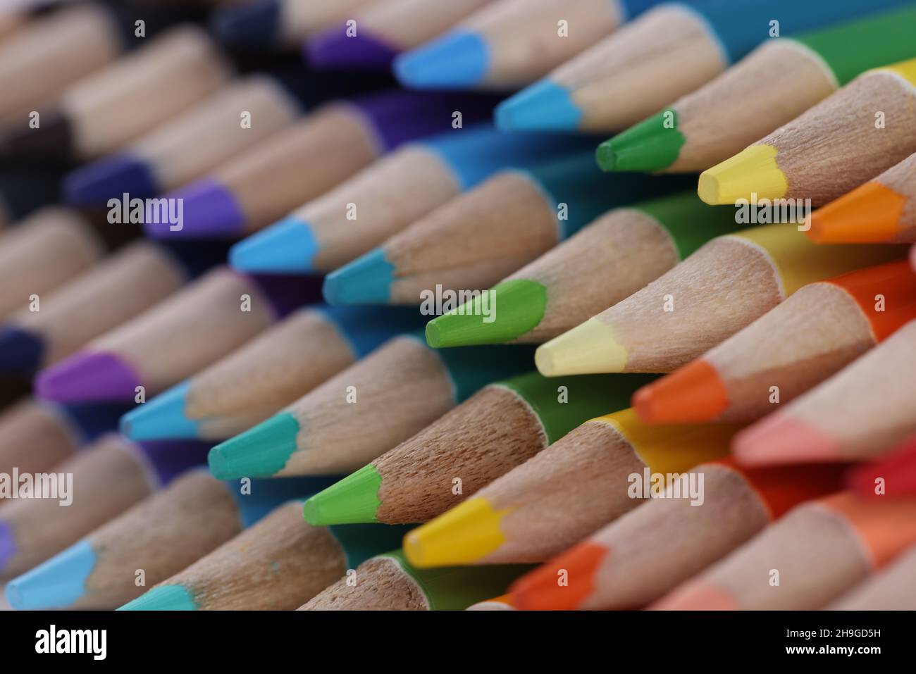 Sharpened pencils for drawing laying on each other forming repeated ...