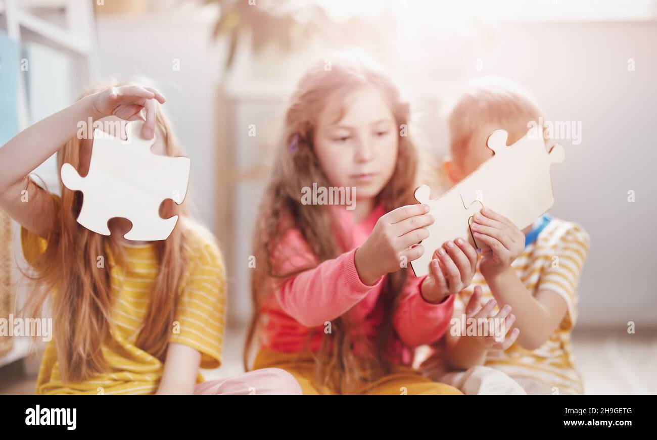 Children playing together jigsaw puzzle hi-res stock photography and ...