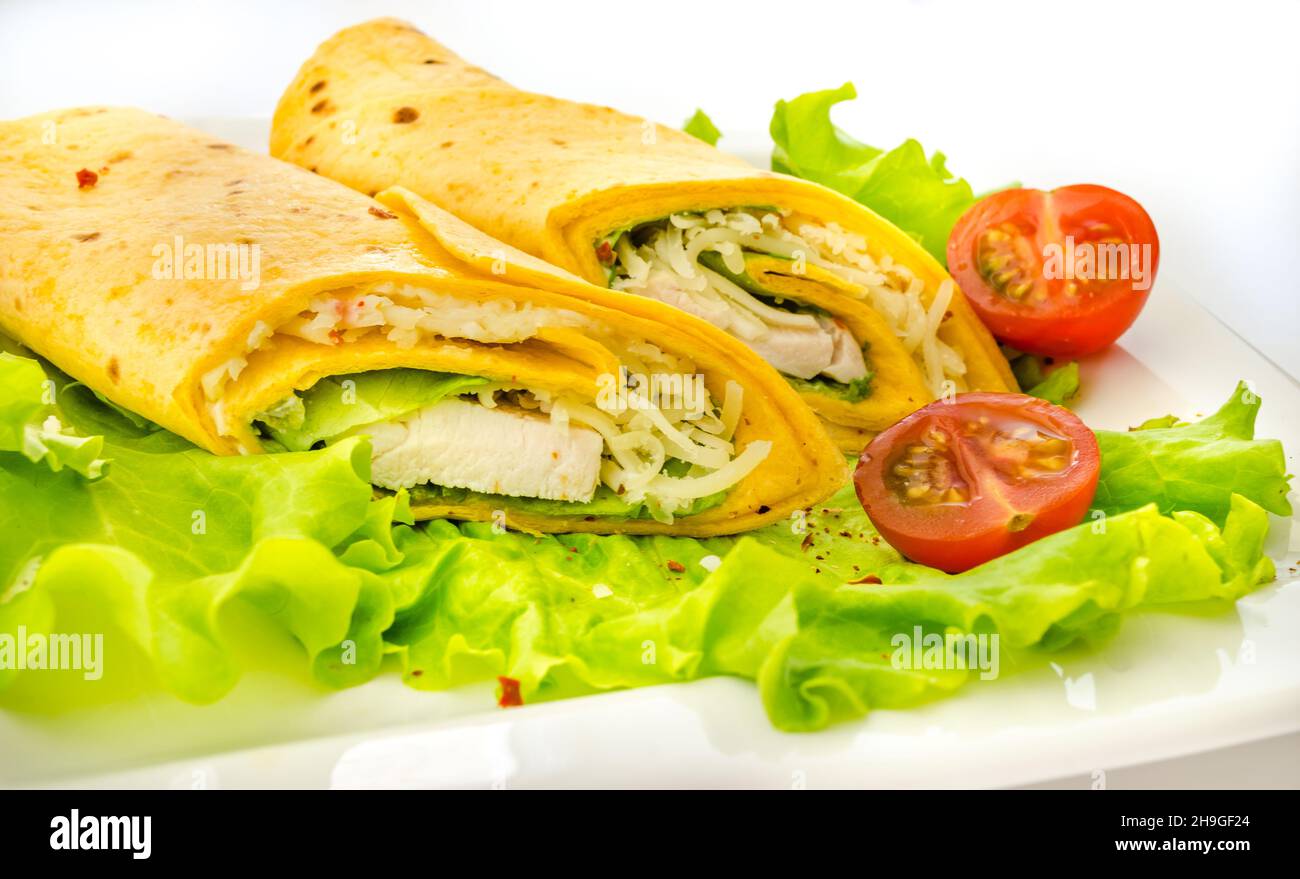 tortilla wraps with chicken and fresh vegetables isolated on white ...