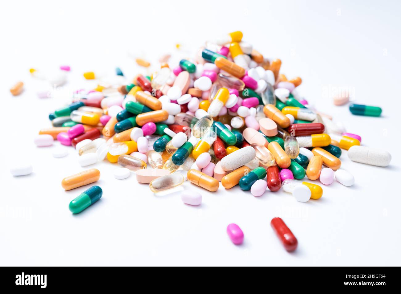 Pile of drugs with a variety of colorful tablets, pills, capsules and ...