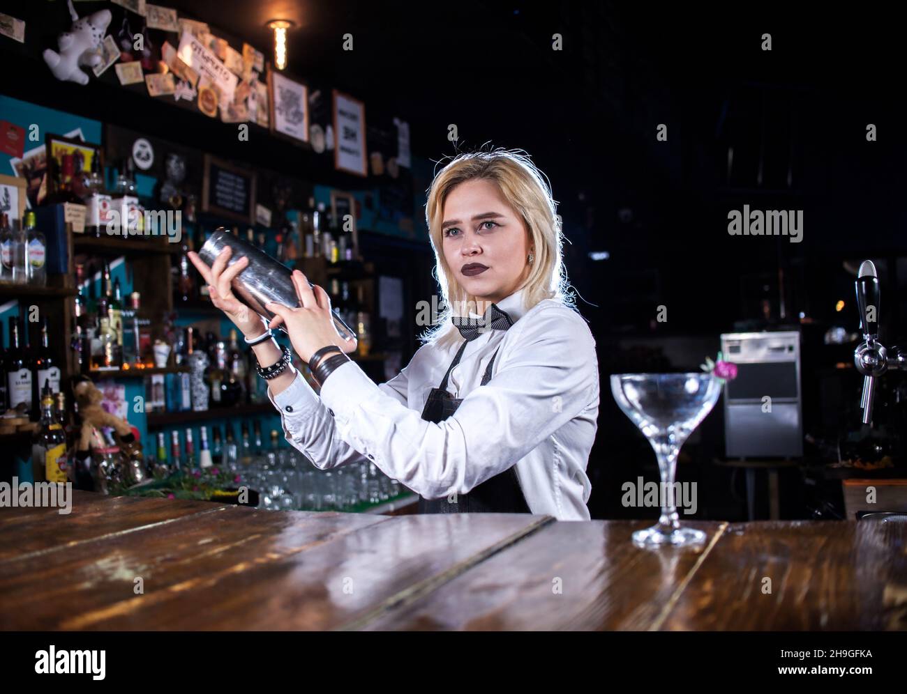 Experienced girl mixologist surprises with its skill bar visitors in the nightclub Stock Photo ...