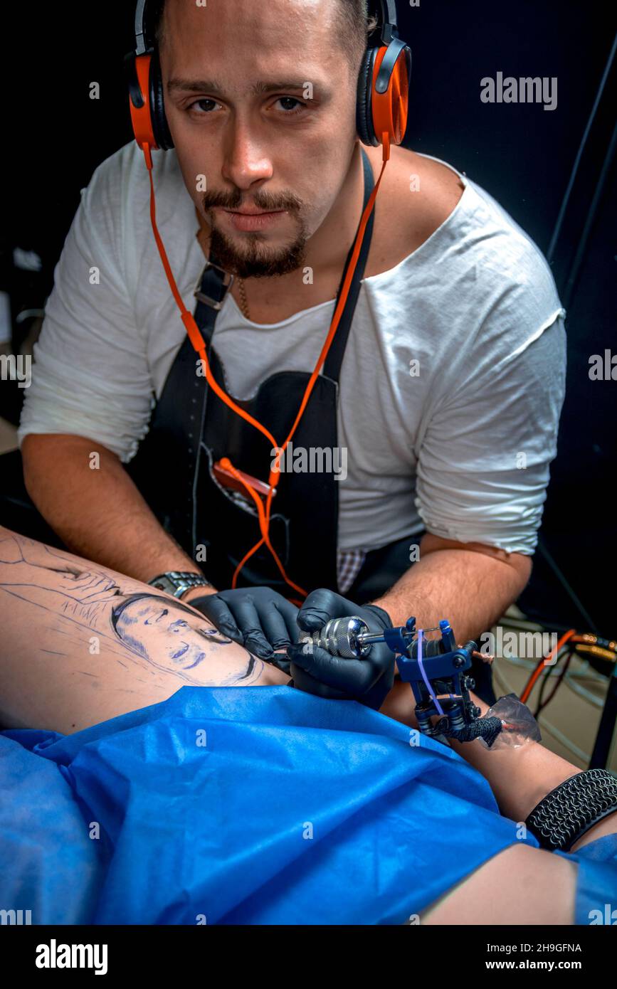 Tattoo artist demonstrates process hi-res stock photography and images ...