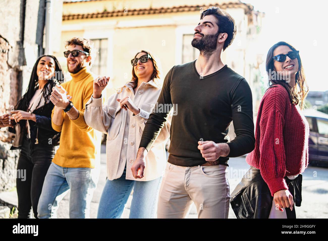 Group of young multicultural people dancing together in the street ...