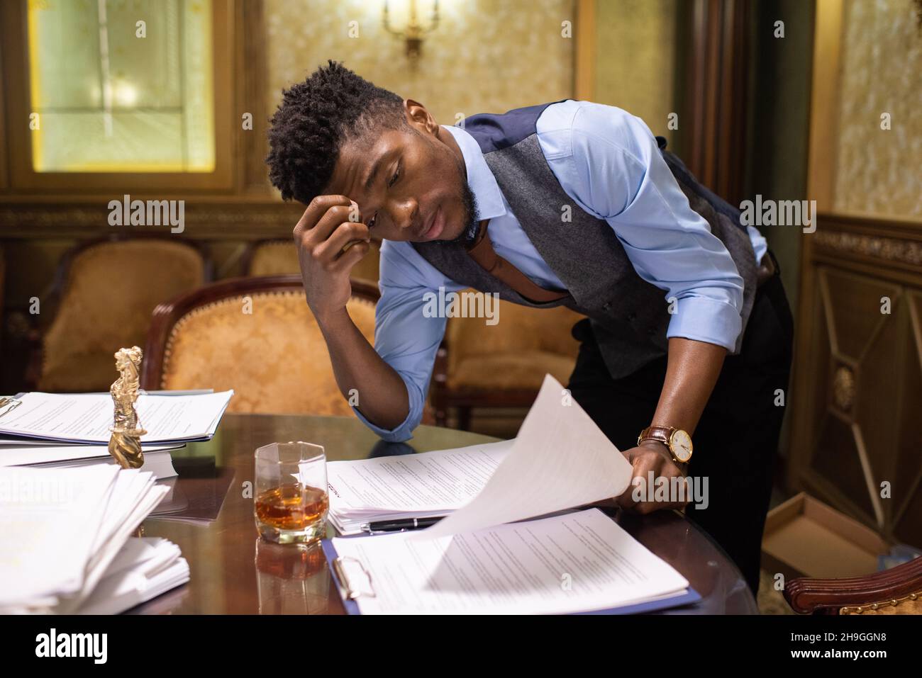 Young man bending over table hi-res stock photography and images - Alamy
