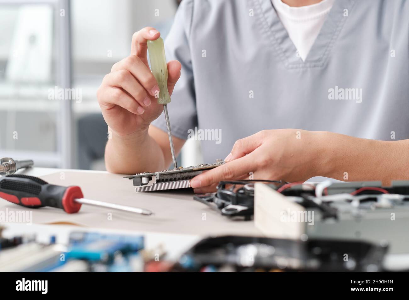 Hands of female troubleshooting technician fixing tiny details of ...