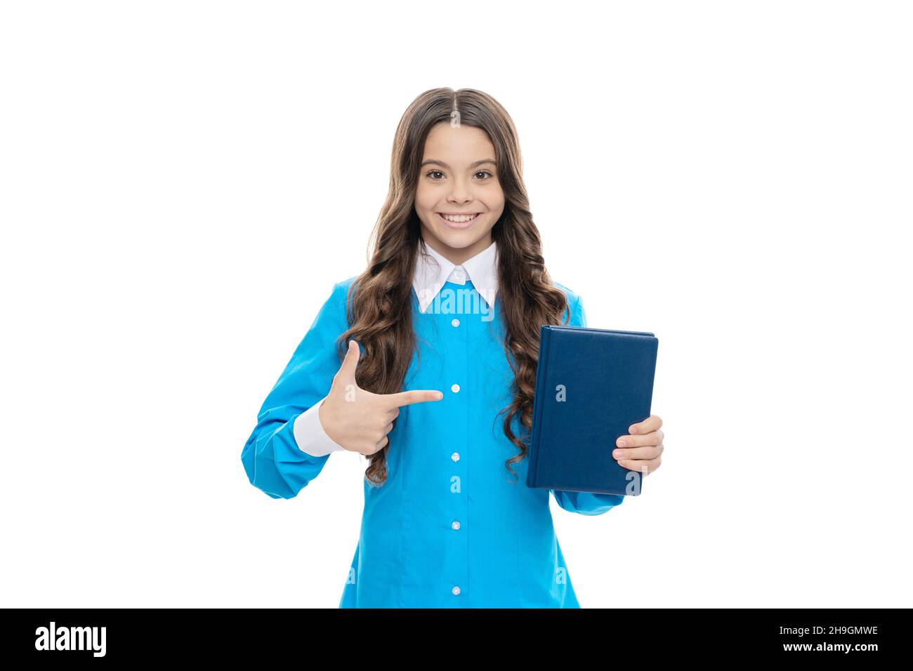 Happy child point index finger at school book isolated on white ...