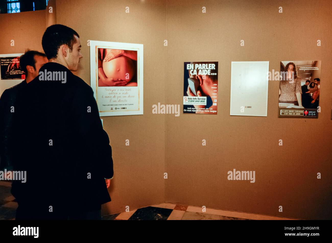 Paris France Men Looking At Collection Aids Posters On Display
