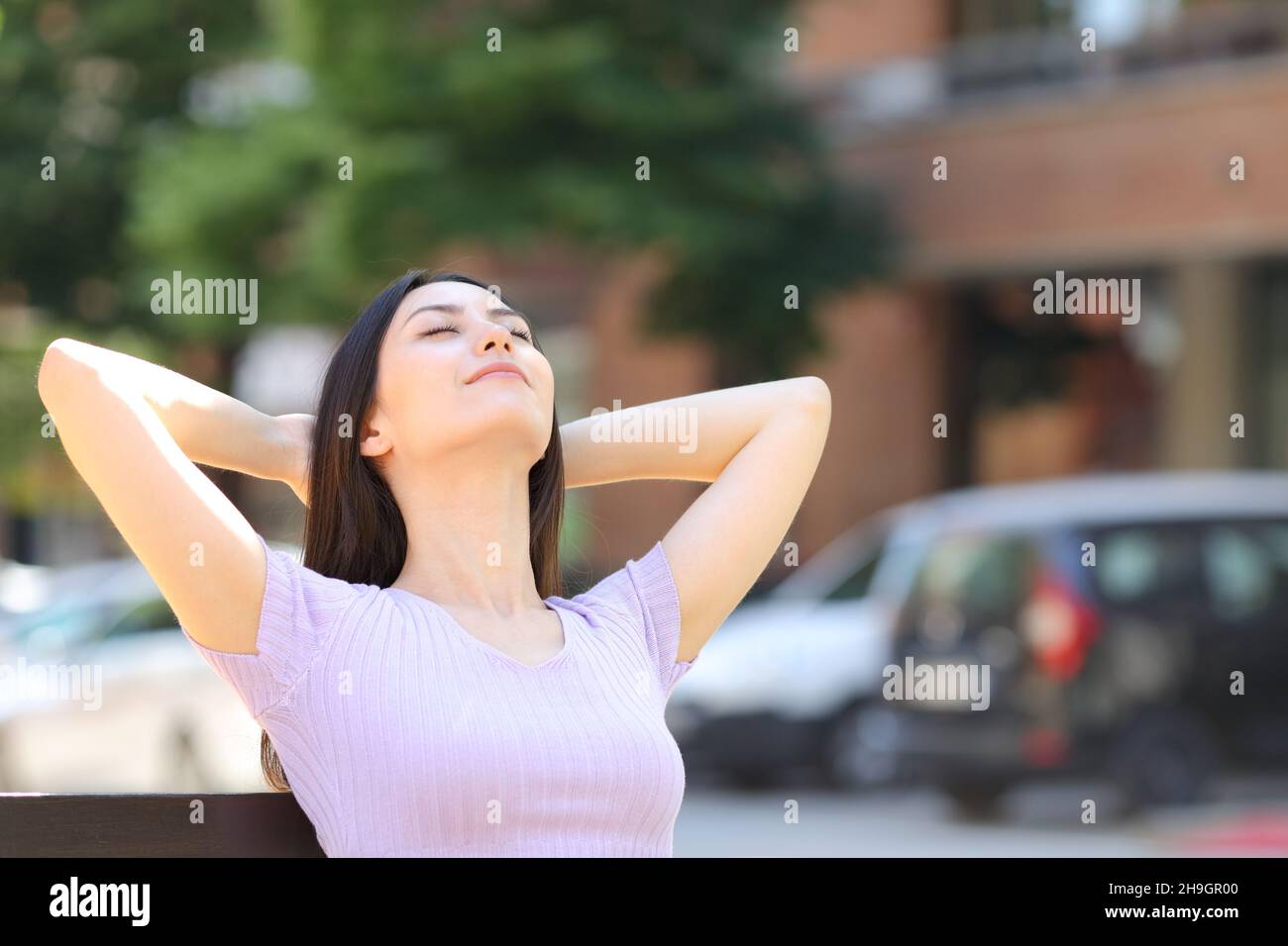 Asian girl sitting on bench hi-res stock photography and images - Alamy