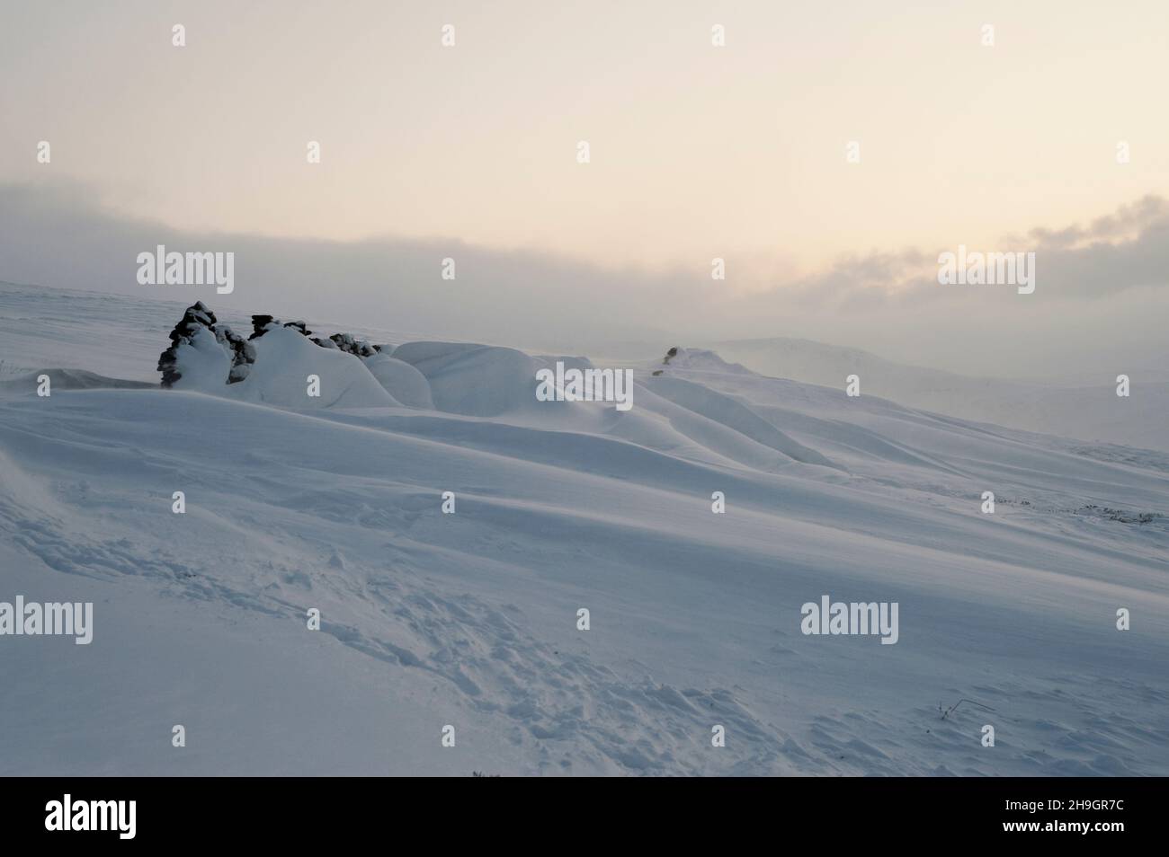 Snow patterns formed by wind blown snow beside a drystone wall, Peak ...