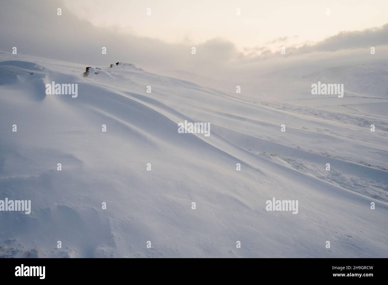 Snow patterns formed by wind blown snow beside a drystone wall, Peak ...
