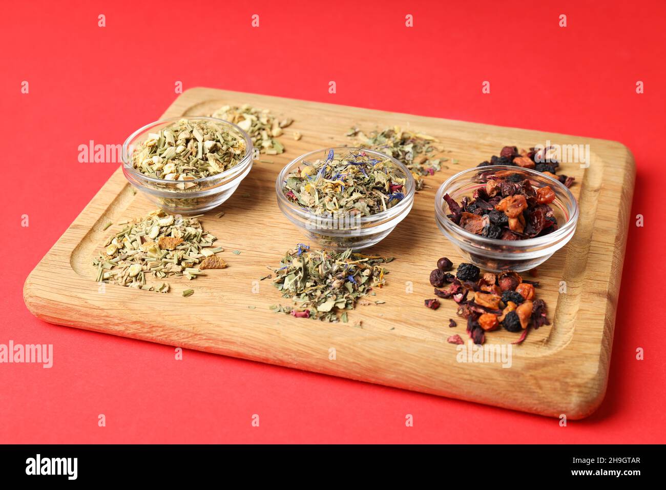 Concept of cooking tea with different types of tea on red background ...