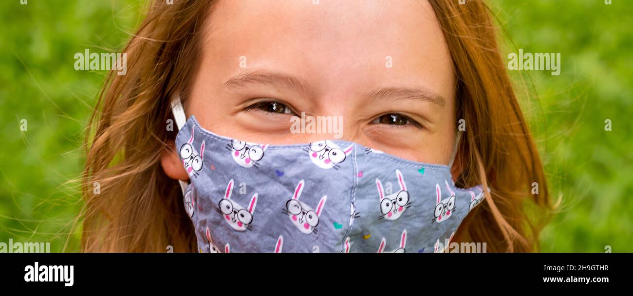 Cheerful girl in a child's face mask smiles. eyes and face mask Stock ...