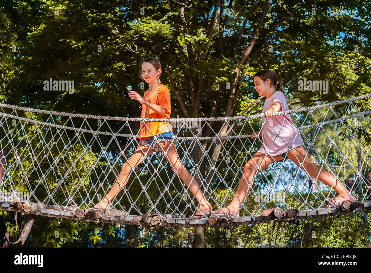 happy children in the playground. crossing a wooden bridge Stock Photo ...