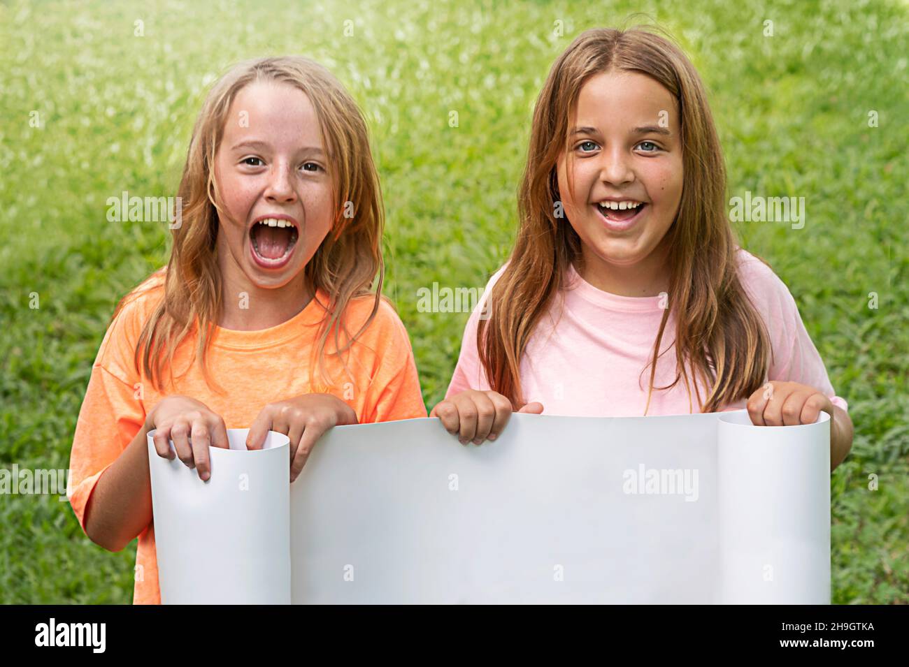 happy children with a white billboard for advertising on a background ...