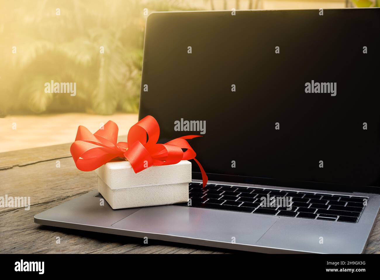 gift box stands on the computer keyboard Stock Photo - Alamy