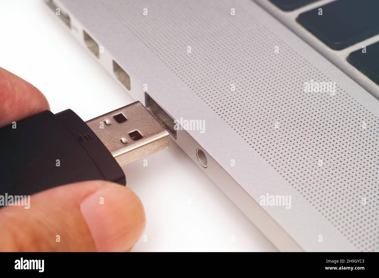 A person hand inserting a USB Flash Drive into a laptop Stock Photo - Alamy