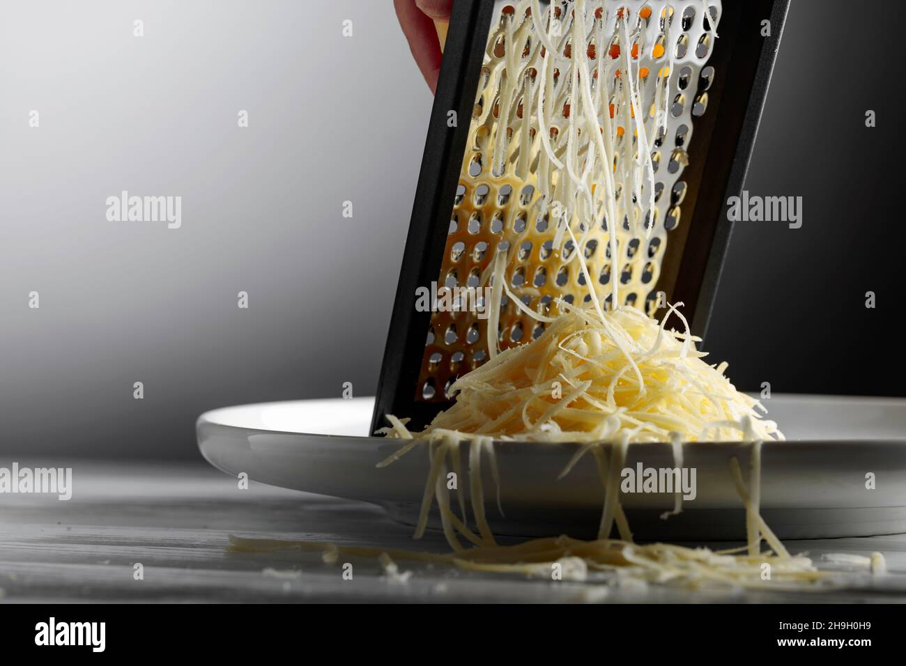 Grated cheese and grater. Concept: Italian cuisine, cheese, restaurant ...