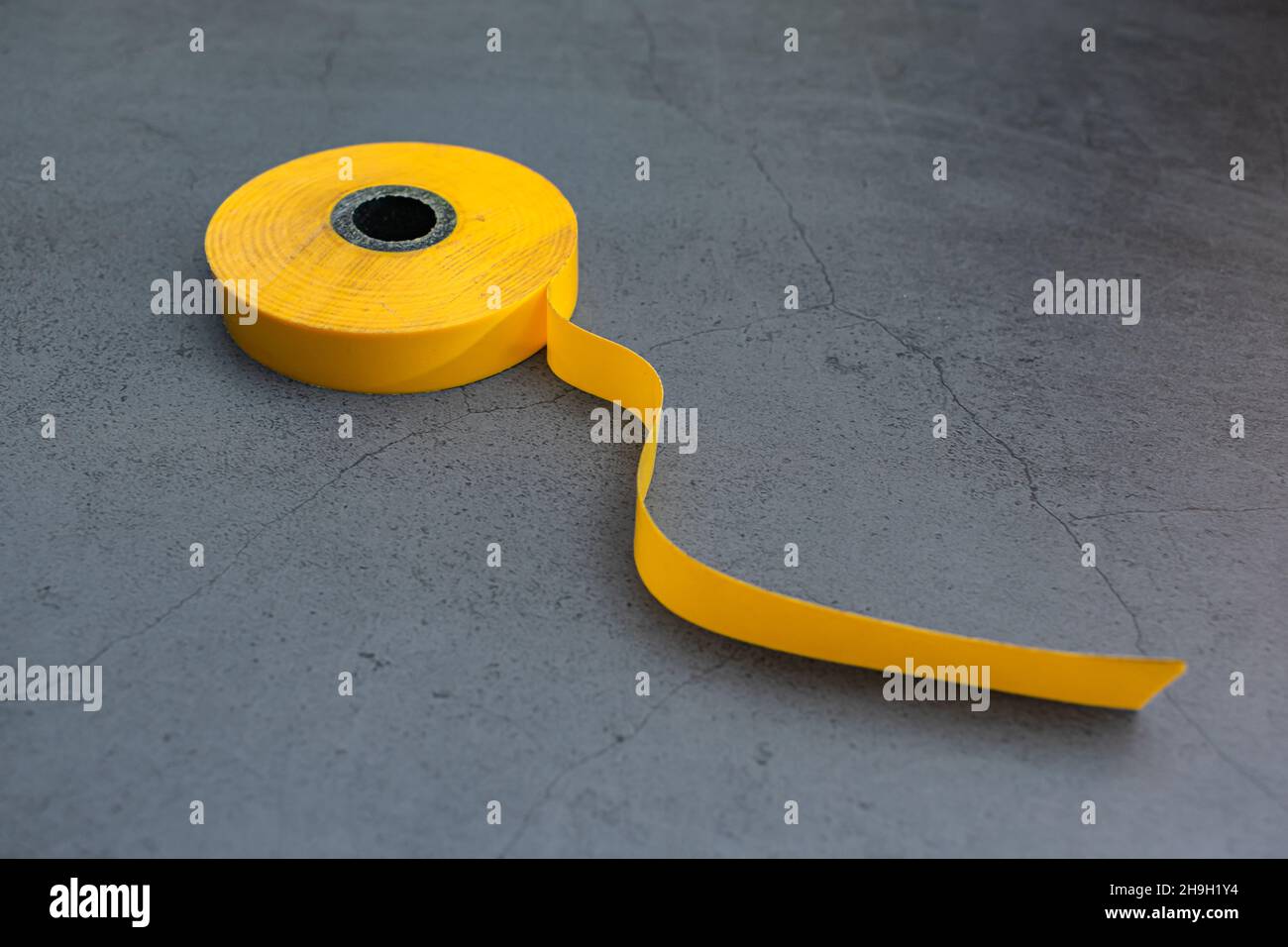 Yellow roll of PVC insulating tape for construction and household work ...
