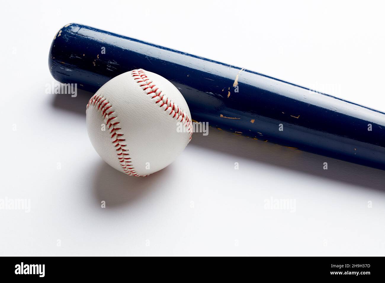 Baseball ball and blue wooden bat on white background with copy space ...