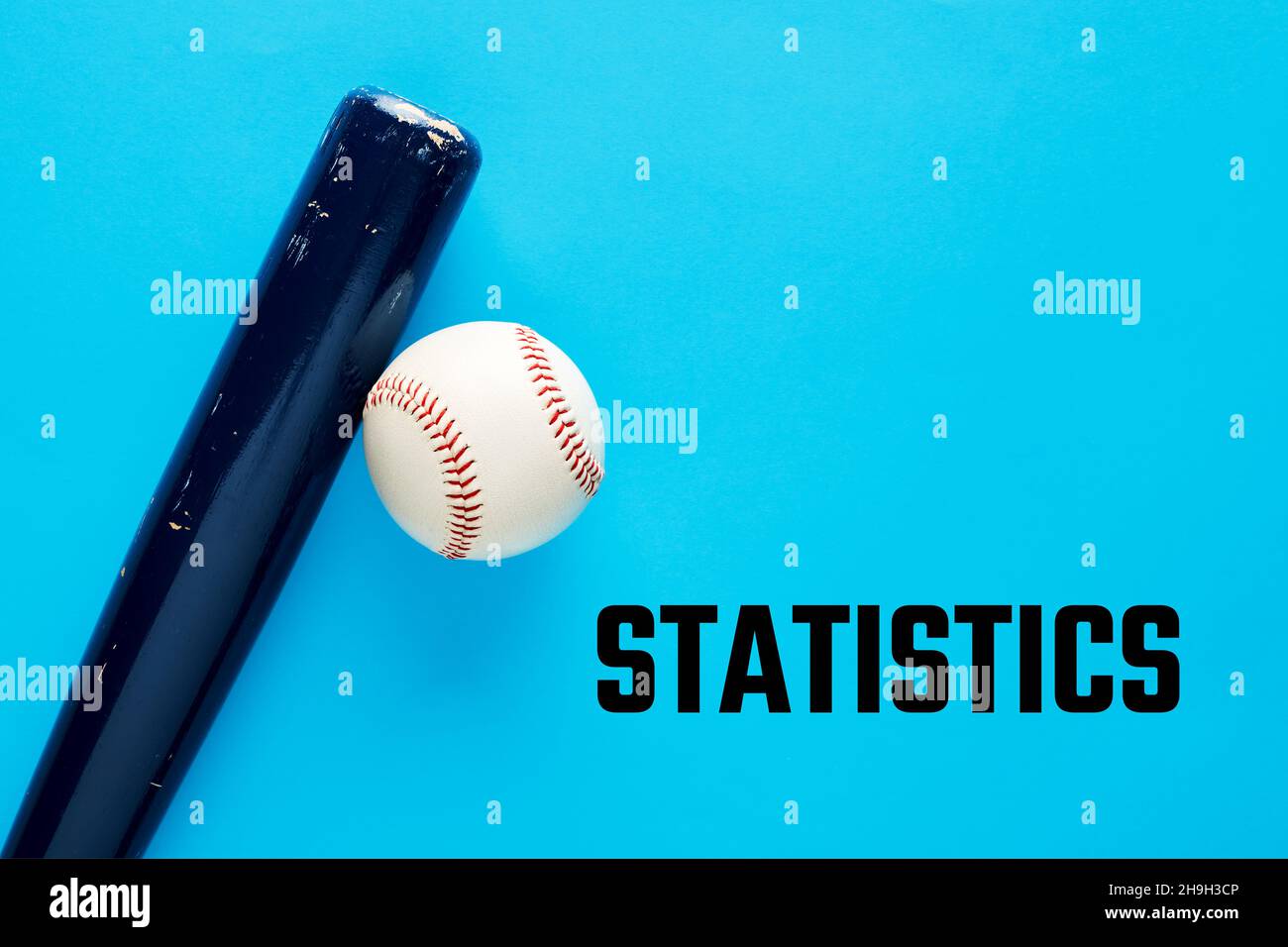 Baseball bat and a ball on blue background with the word statistics ...