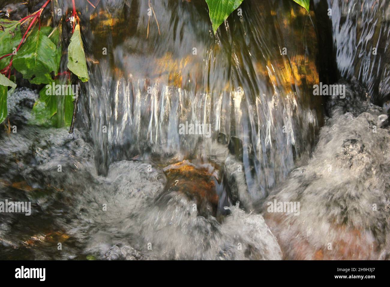 Fresh clean water rushing down a waterfall in the bright sunshine Stock ...
